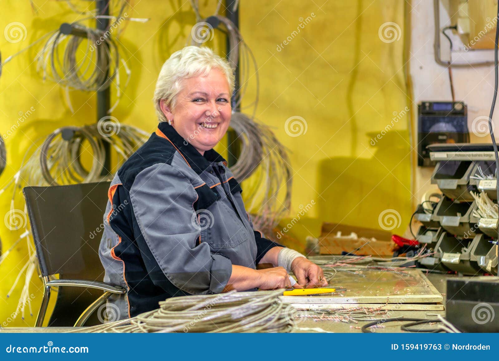 Small Cable Installation Plant. Electric Workshop Workers Knit a Cable ...