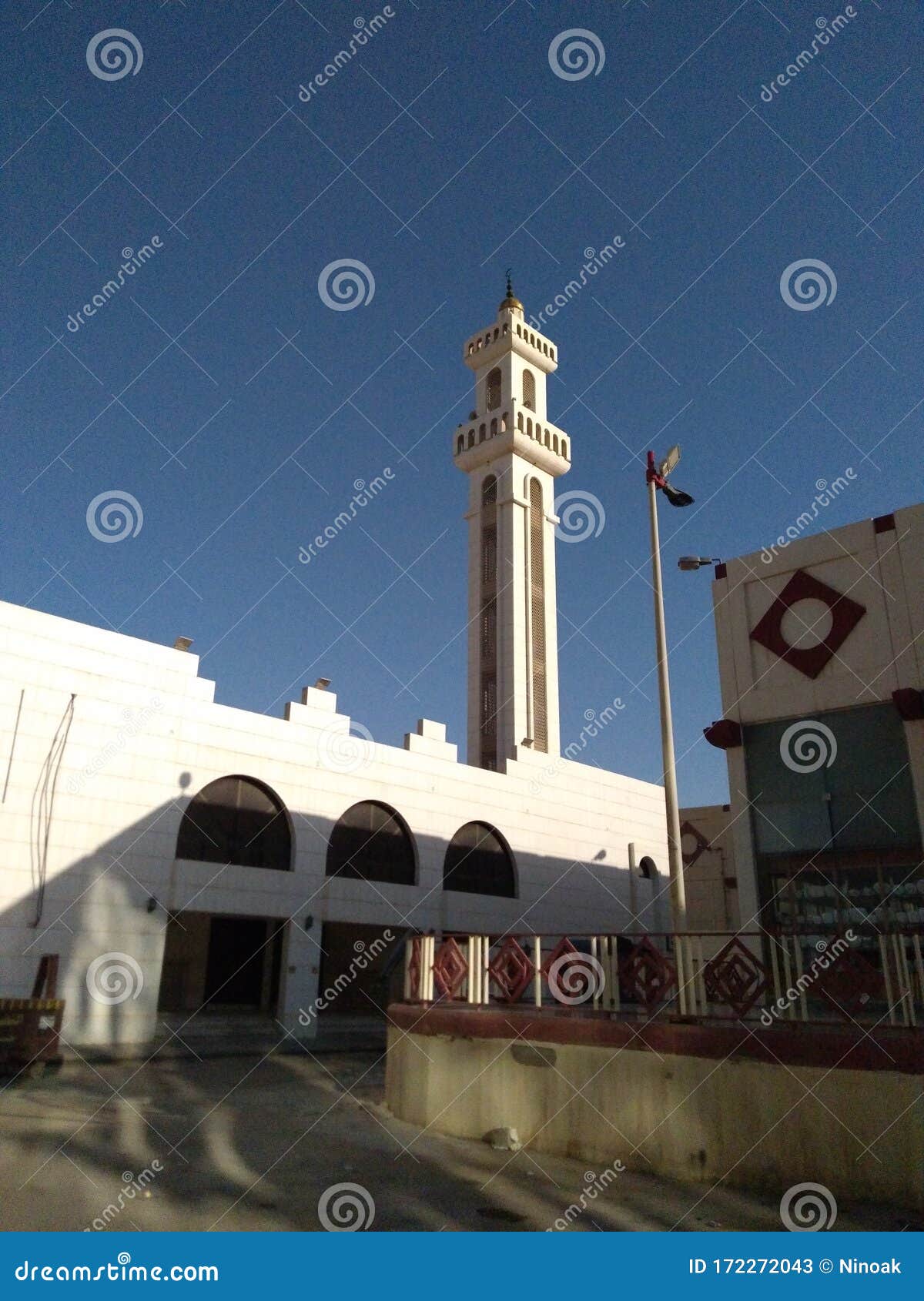 Mosque with Square Minaret Illuminated by Sunlight with One Balcony and ...