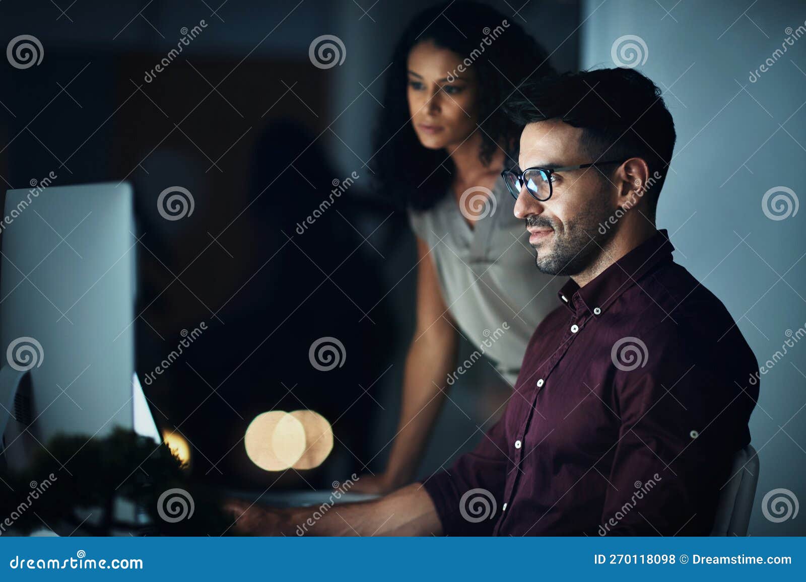 The Most Focused Team on a Late Night Task. Two Colleagues Using a ...