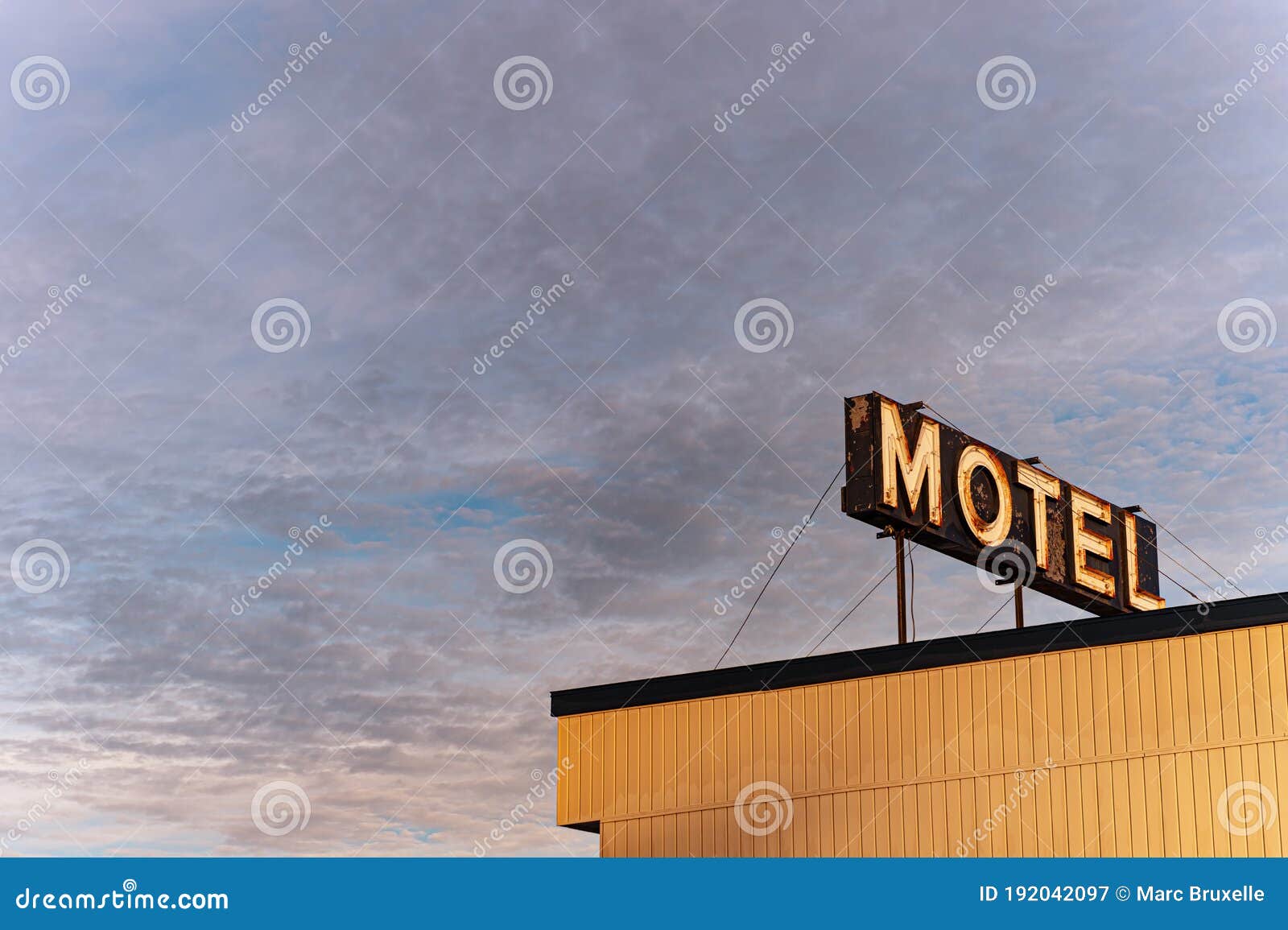 Motel Neon Sign Over a Cloudy Sky Stock Image - Image of cloudy, neon ...