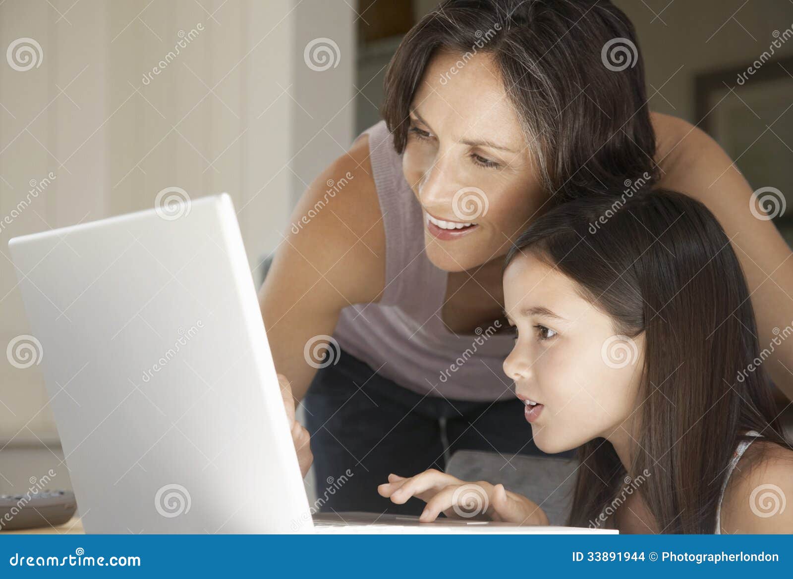 Mother Assisting Daughter in Using Laptop Stock Photo - Image of ...