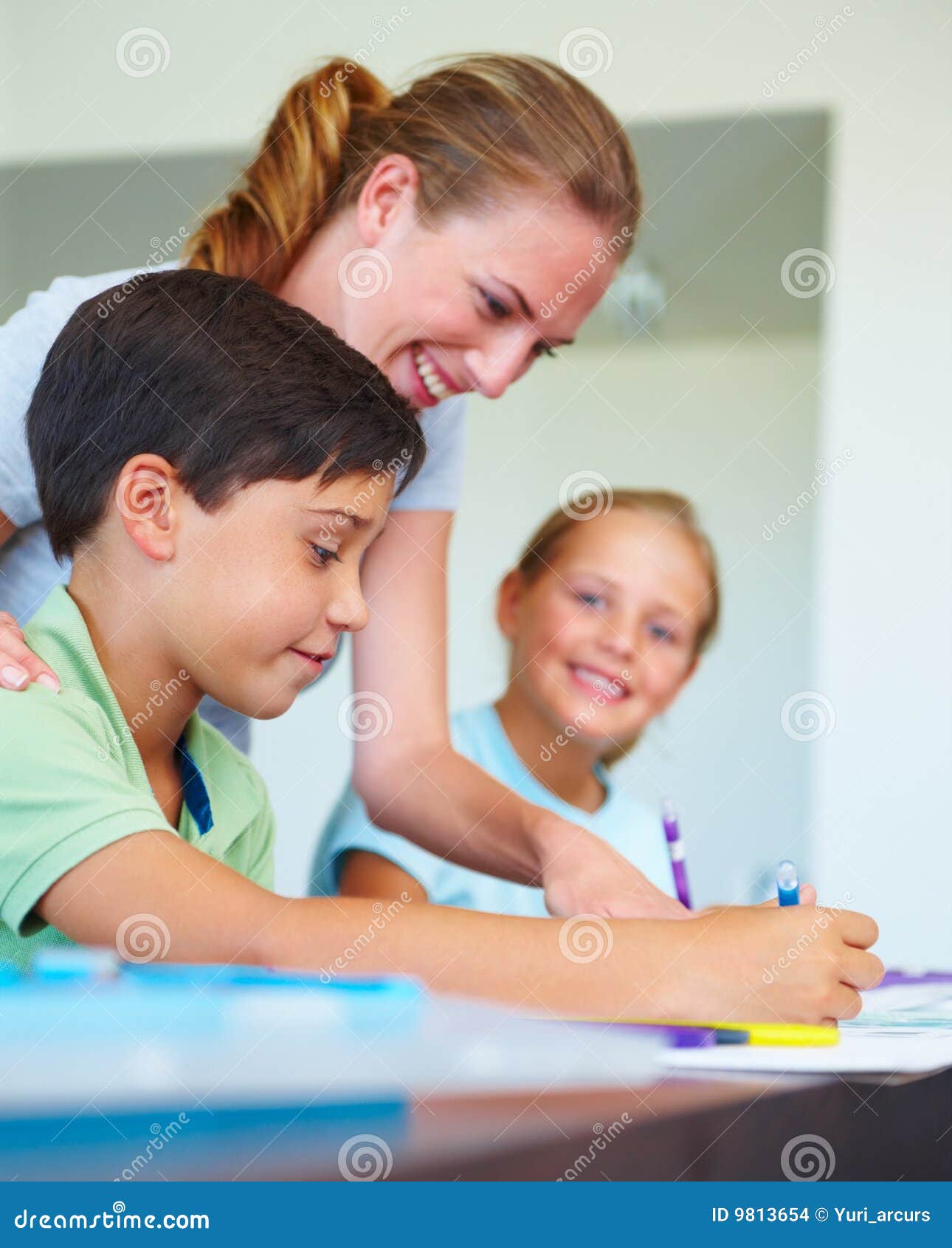 Mother Assisting Her Children in Their Homework Stock Photo - Image of ...