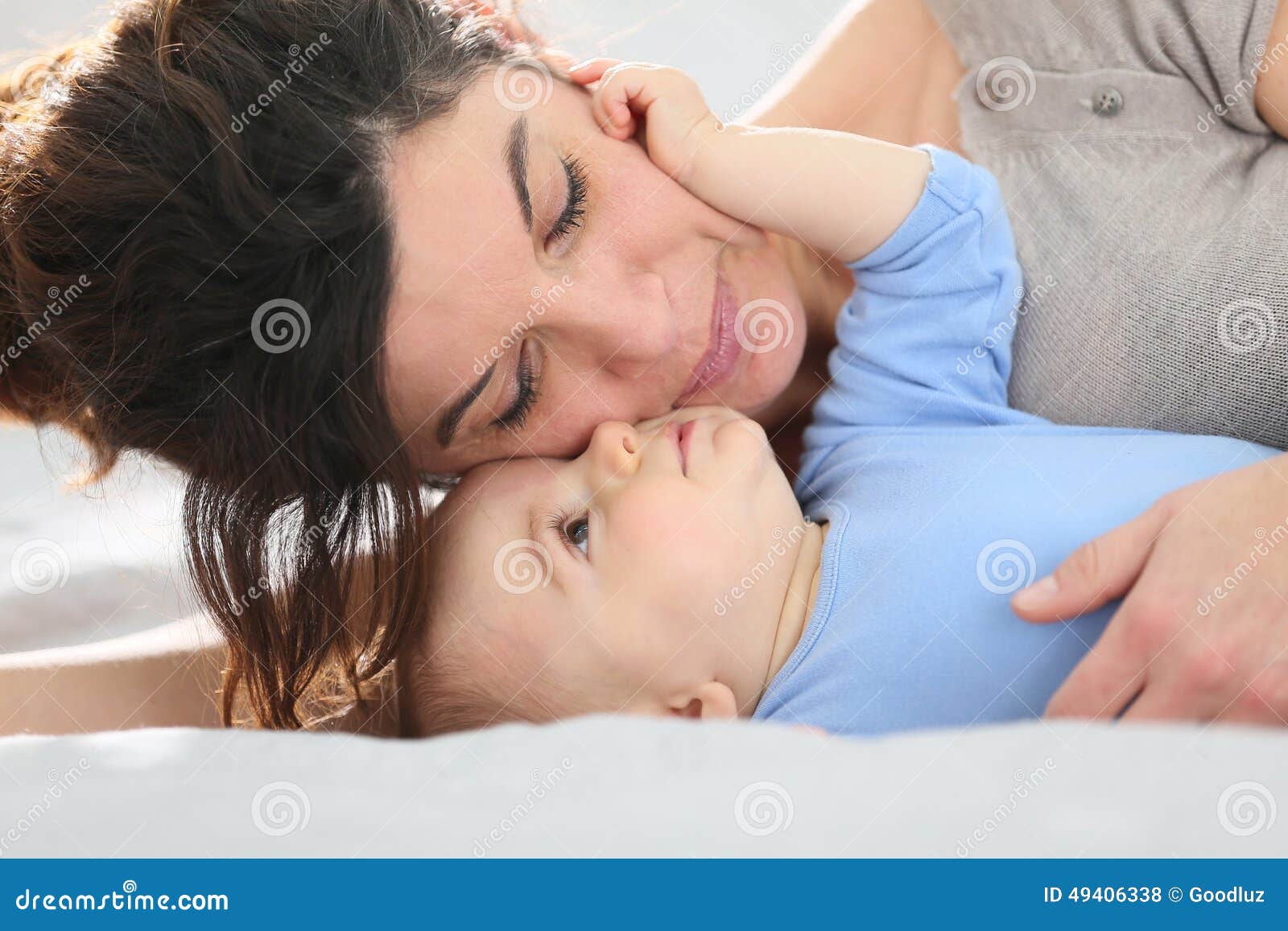 Mother and a baby cuddling stock photo. Image of kissing - 49406338