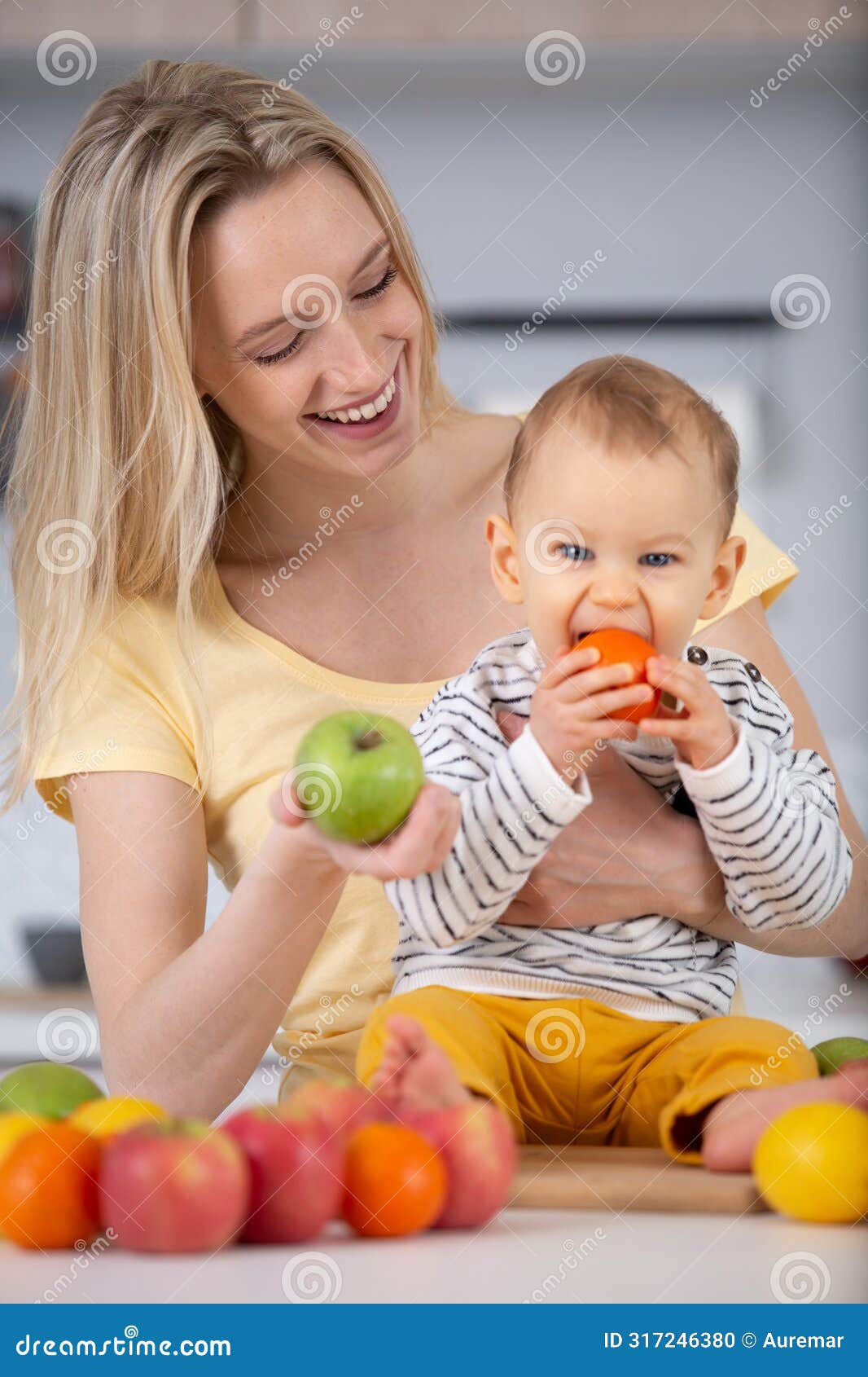 Mother with Baby Eating Fruit Stock Photo - Image of month, camera ...