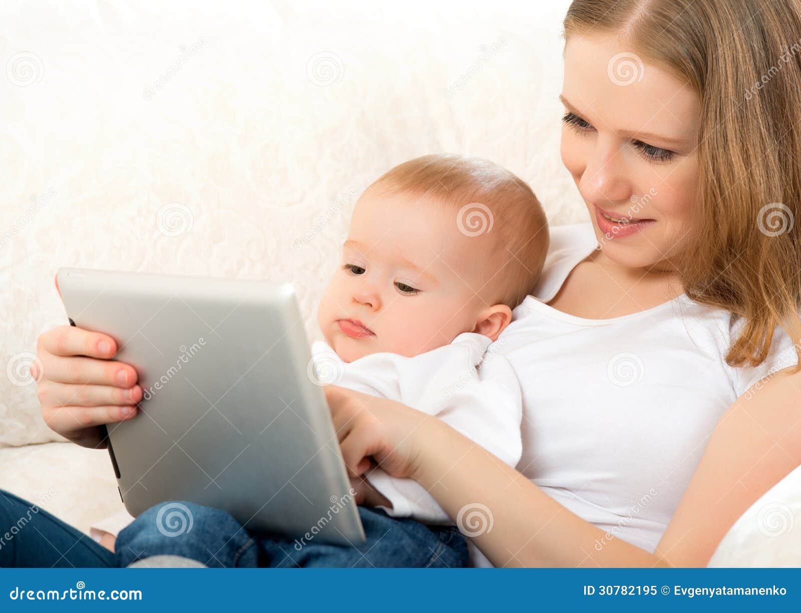 Mother and Baby with Tablet Computer on the Couch at Home Stock Image ...