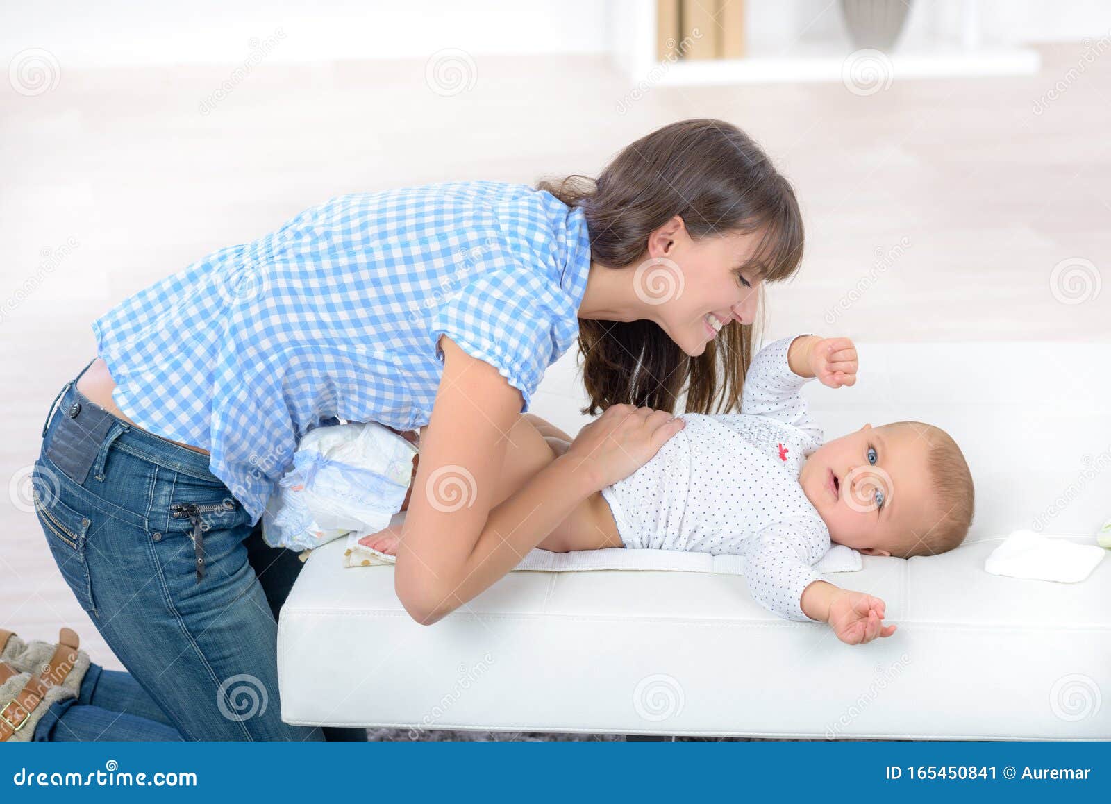 Mother changing baby child stock image. Image of love - 165450841
