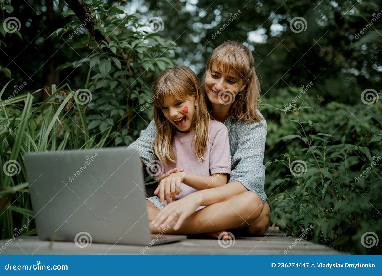 Mother with Child are Playing on Laptop in the Garden Stock Image ...