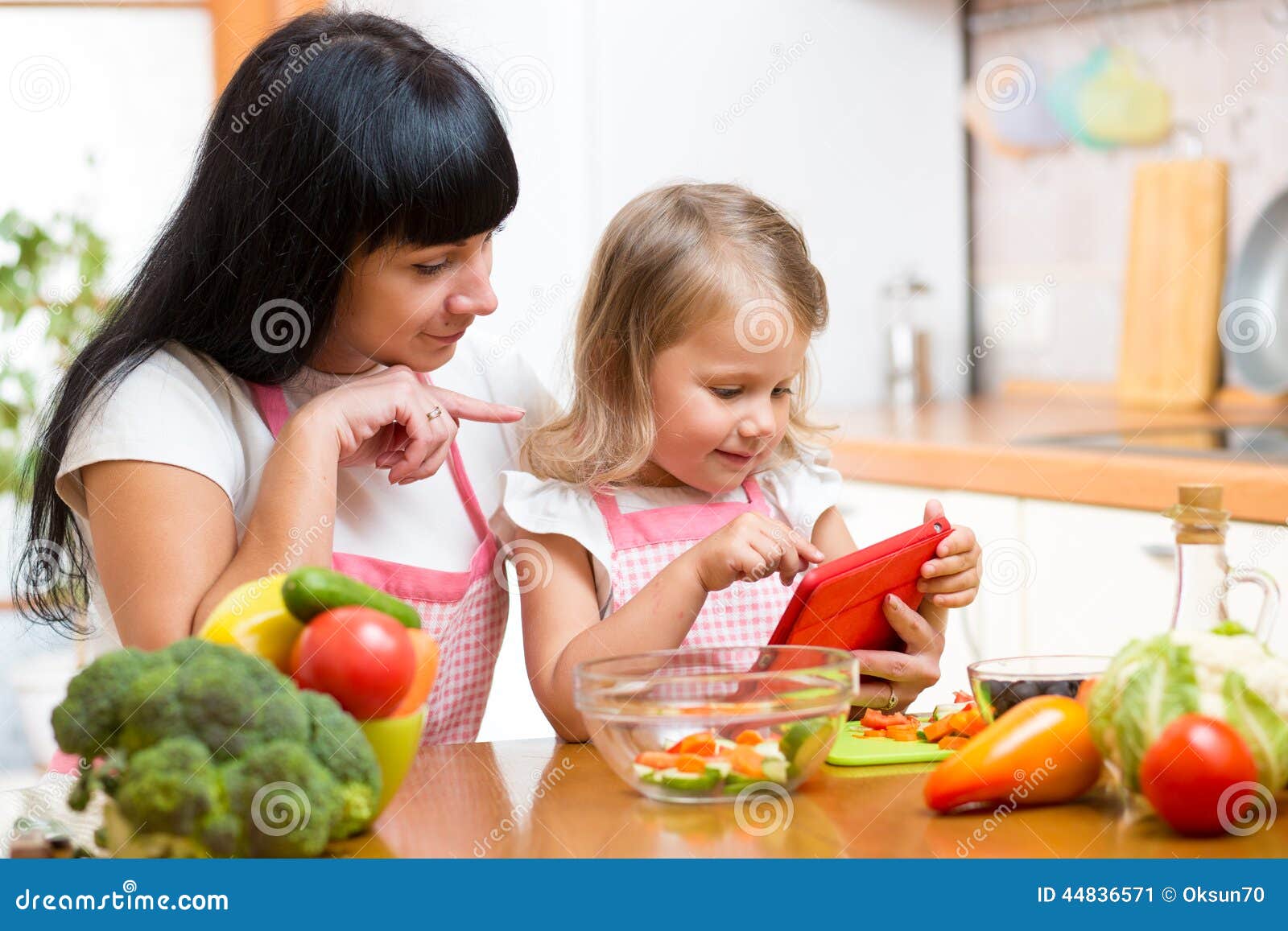 Mother and Child Preparing Vegetables Together at Kitchen and Lo Stock ...
