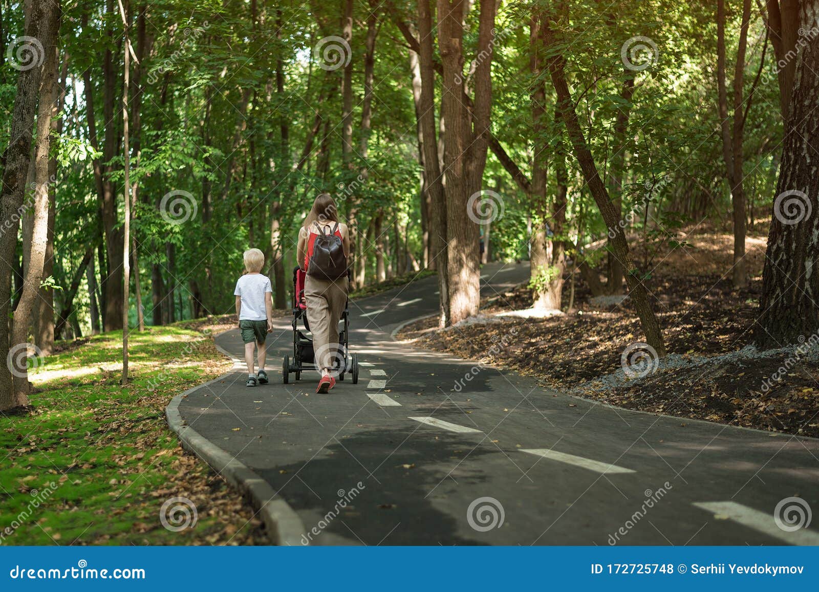 Mother with Children and Stroller Walks in Park. Walks Outdoors Stock ...