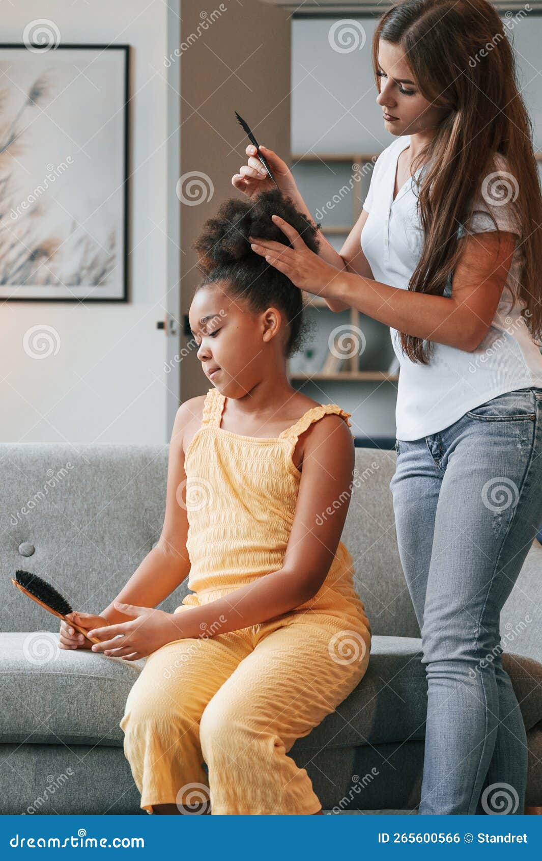 Mother Is Combs Hair Young Woman With Her Daughter Is Together At