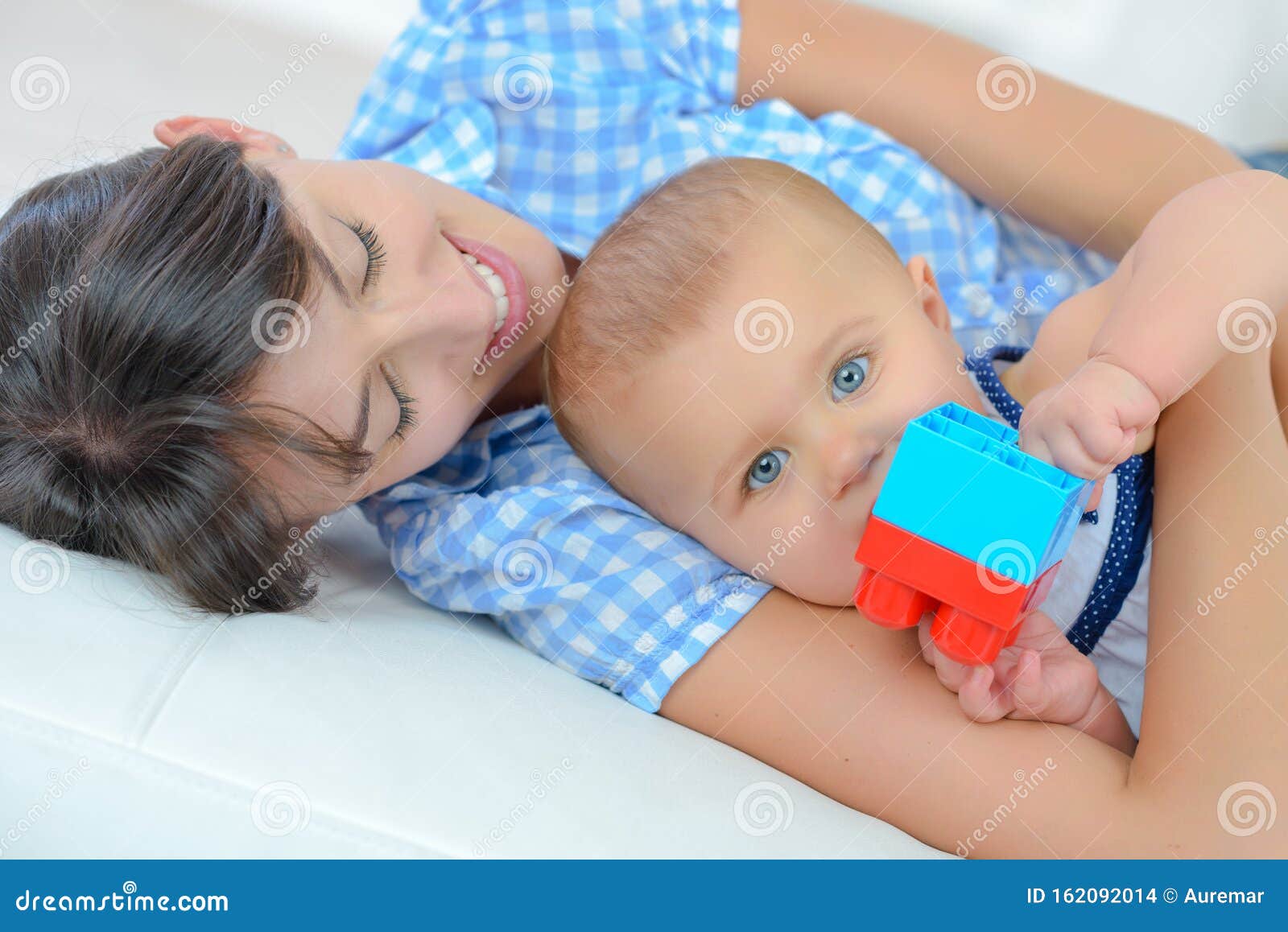 Mother cuddling baby girl stock photo. Image of childhood - 162092014