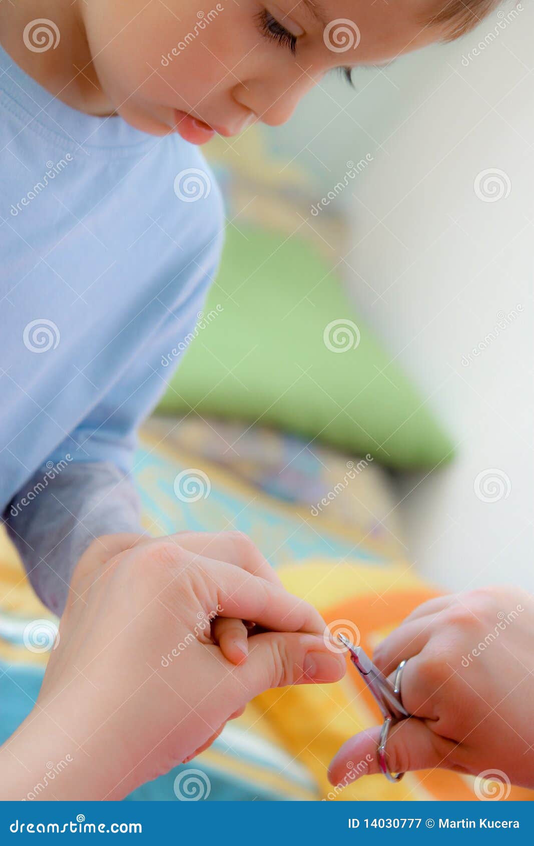 Mother cutting boy s nails stock image. Image of home - 14030777