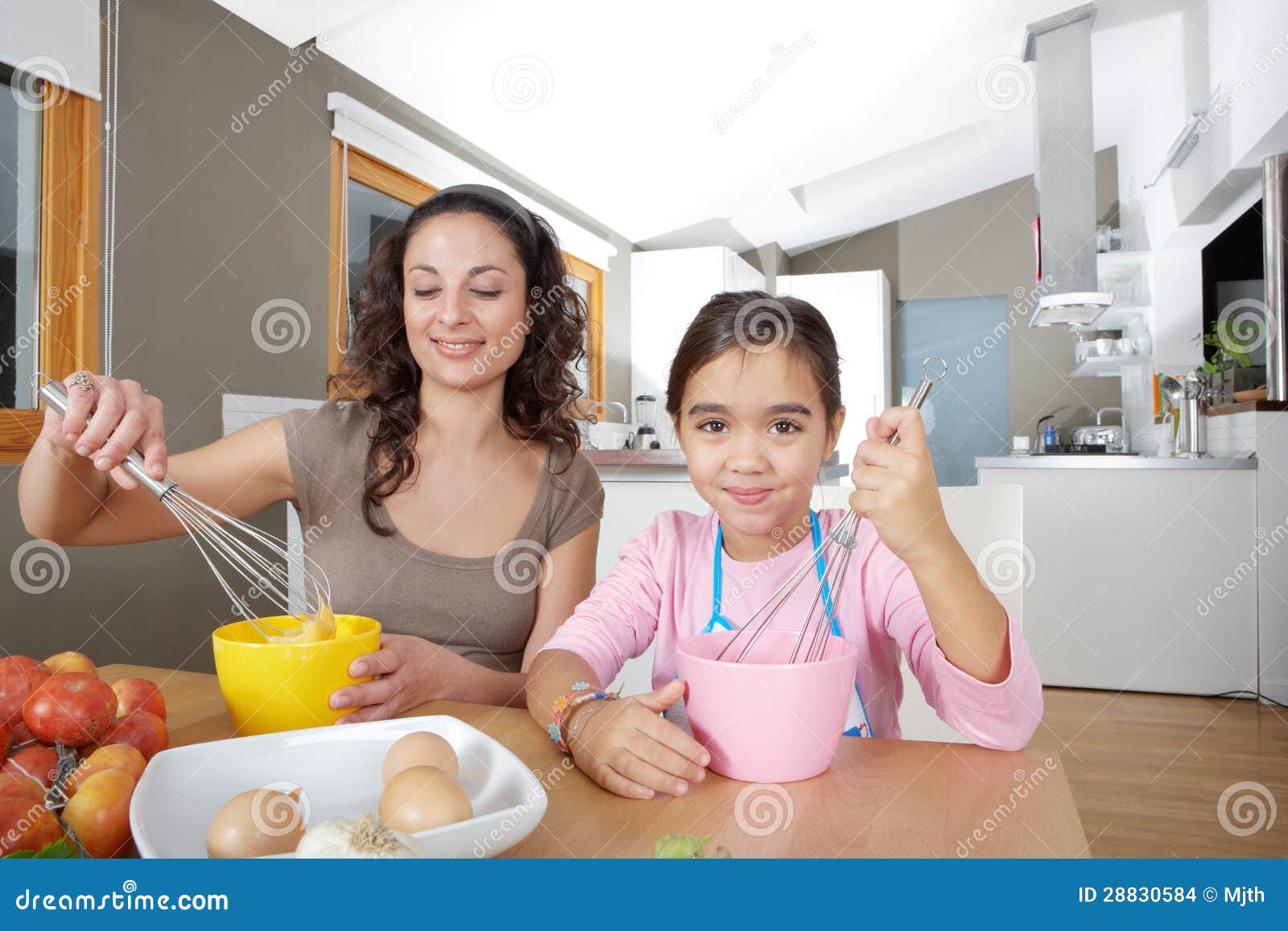 Mother and Daughter Beating Eggs in Kitchen Stock Photo - Image of ...