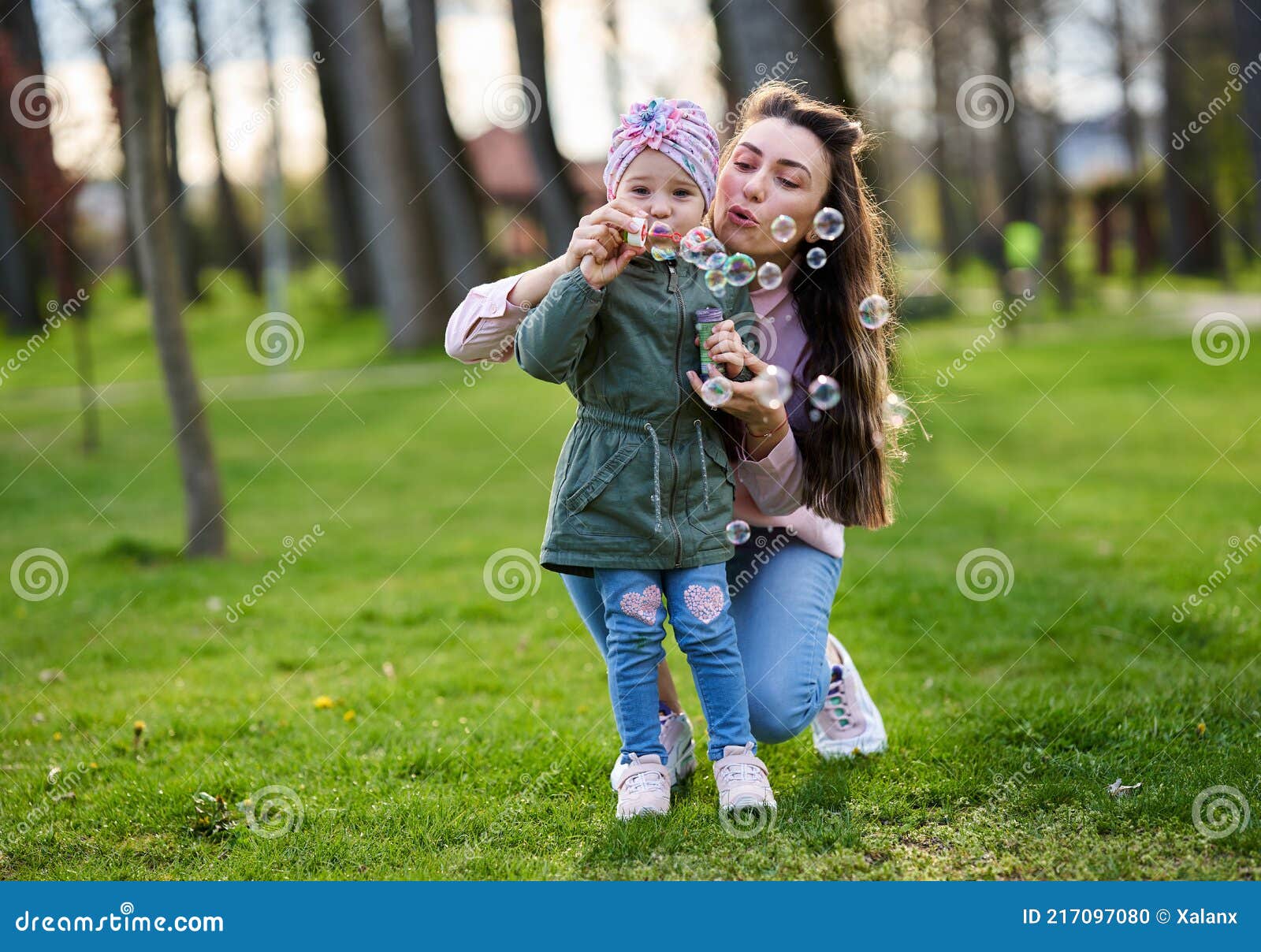 Mother and Daughter Blowing Soap Bubbles Stock Photo - Image of ...
