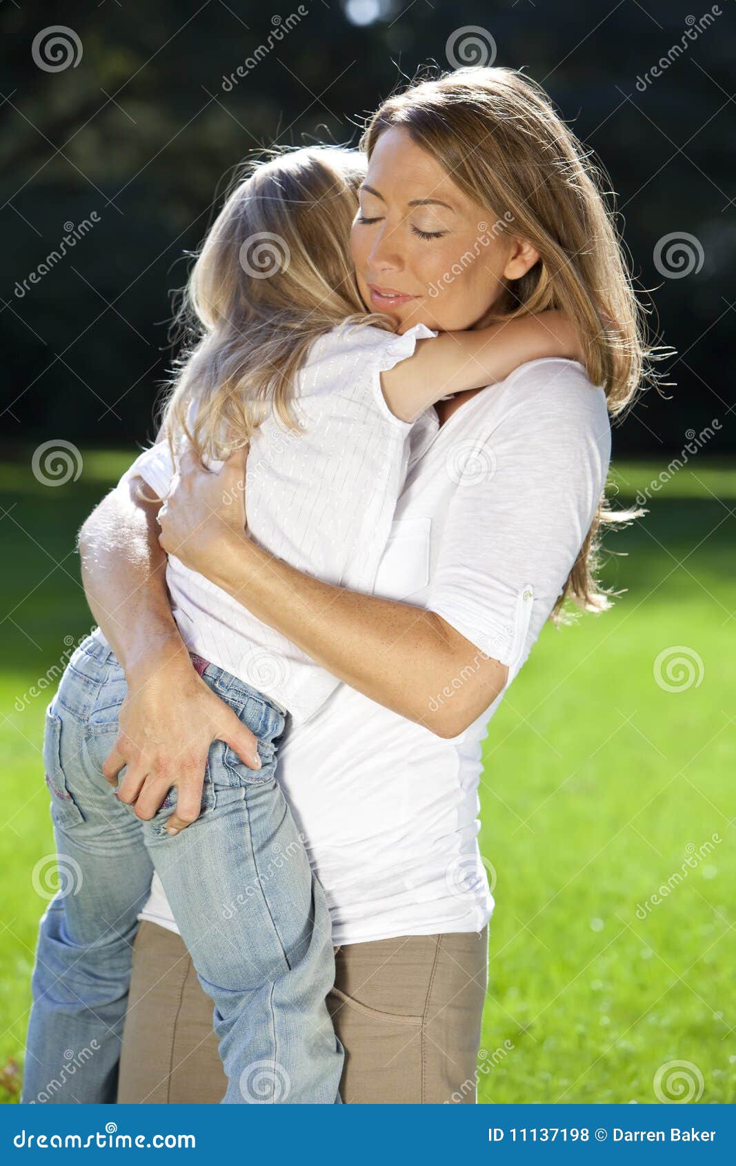 Mother and Daughter Cuddling in a Park Stock Photo - Image of parenting ...