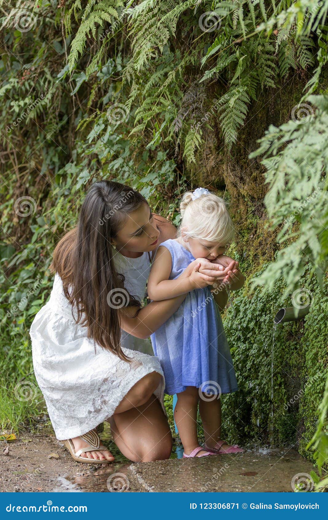 Mother with a Daughter Drink Water from a Source Stock Image - Image of ...