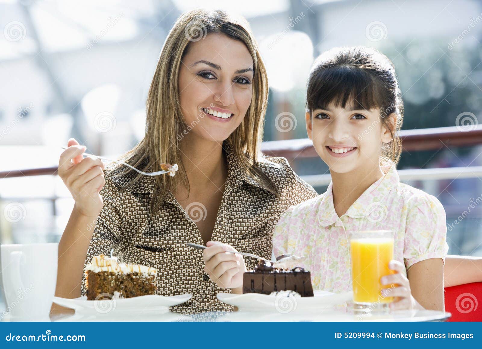 Mom With Her Daughter Eating Chocolate Flakes Have A Good Time
