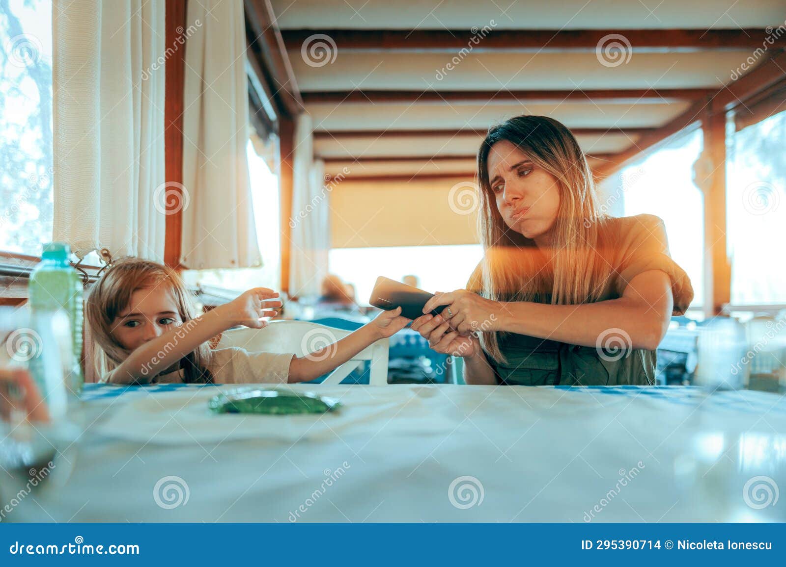 Mother and Daughter Fighting Over the Mobile Phone Stock Photo - Image ...