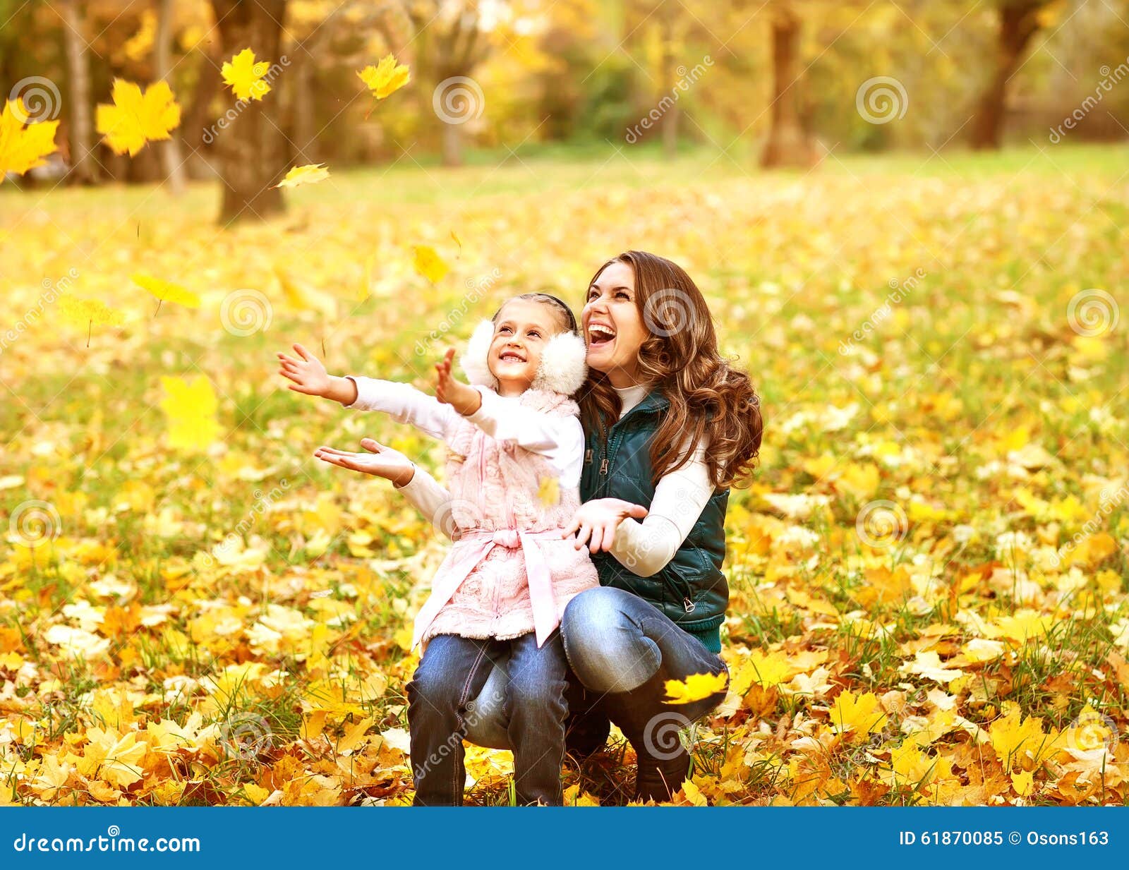 Mother and Daughter Having Fun in the Autumn Park among the Fall Stock ...