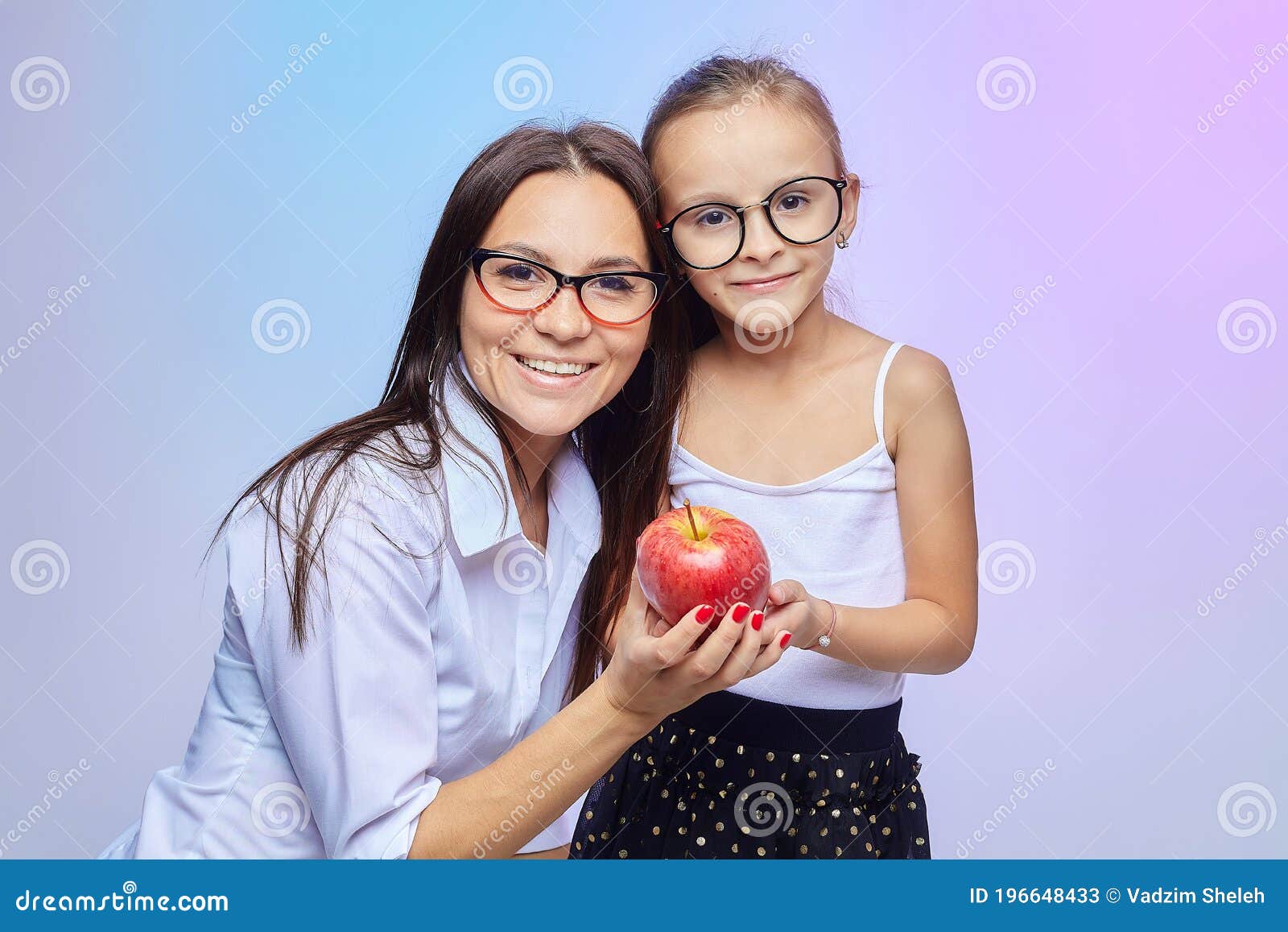 Mother and Daughter Hold a Large Red Apple in Their Hands Stock Image ...