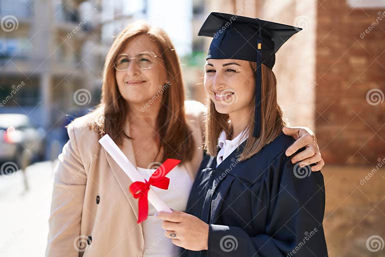 Mother And Daughter Hugging Each Other Celebrating Graduation At