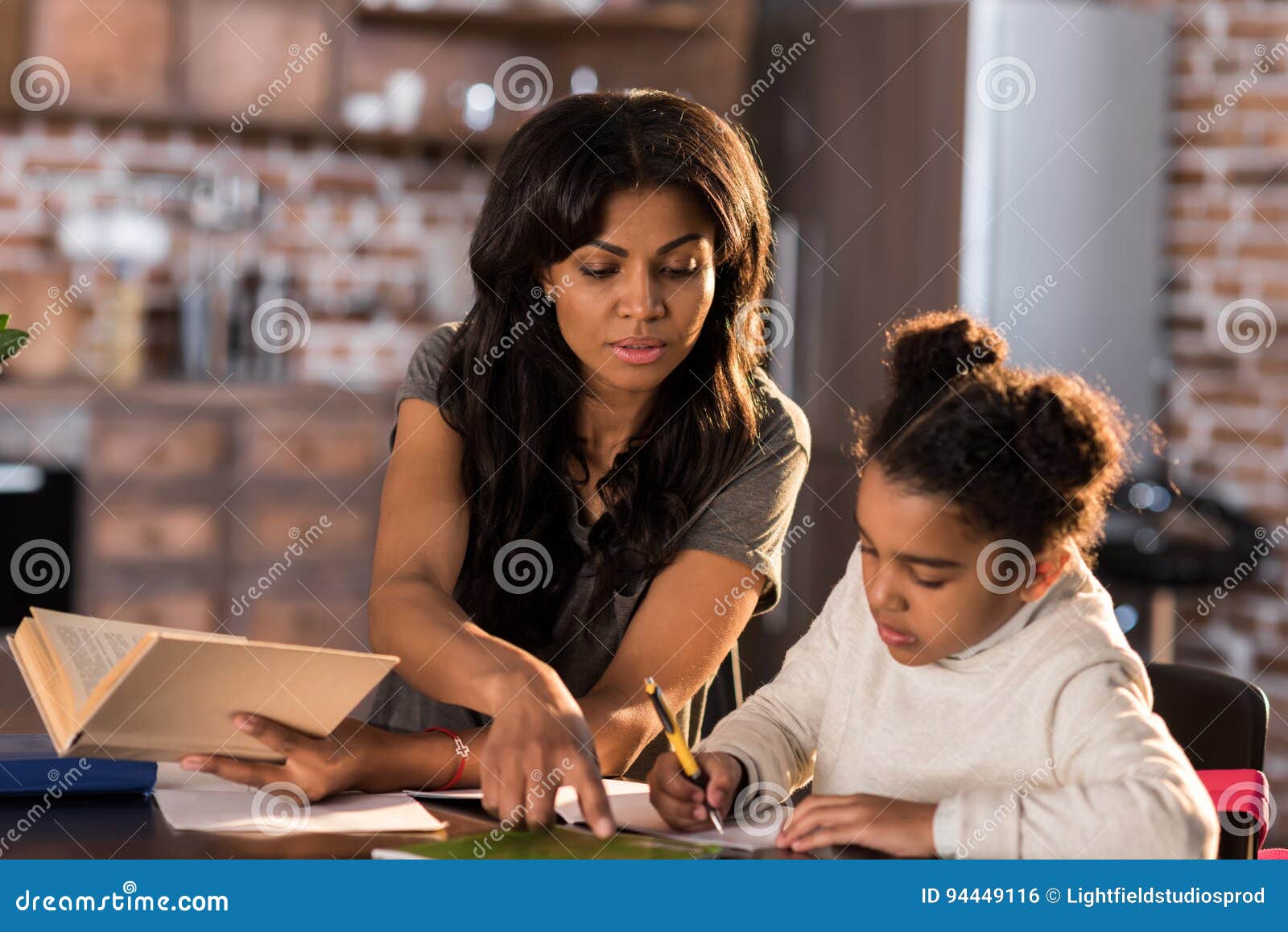 Mother and Daughter Learning Together at Table and Doing Homework Stock ...