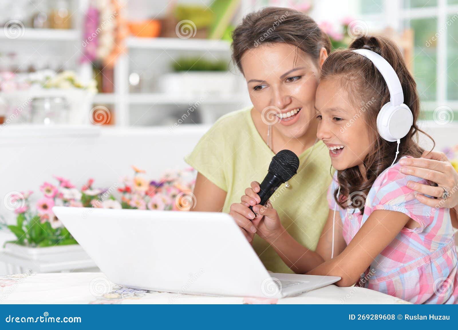 Mother and Daughter Looking at Laptop Singing Karaoke Stock Photo ...
