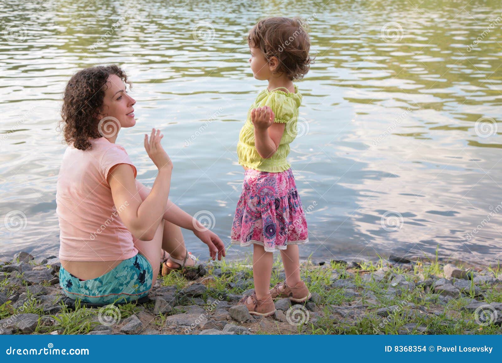 Mother with Daughter Near Water Stock Photo - Image of summer, grass ...