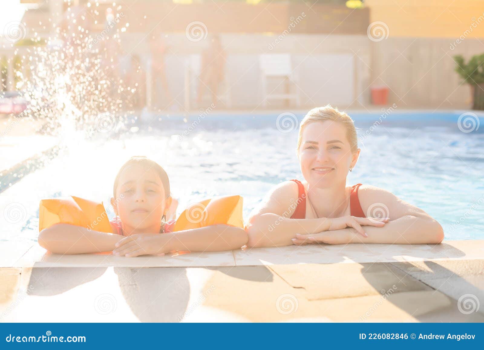 A Mother and Daughter Playing in the Pool Stock Photo - Image of latin ...