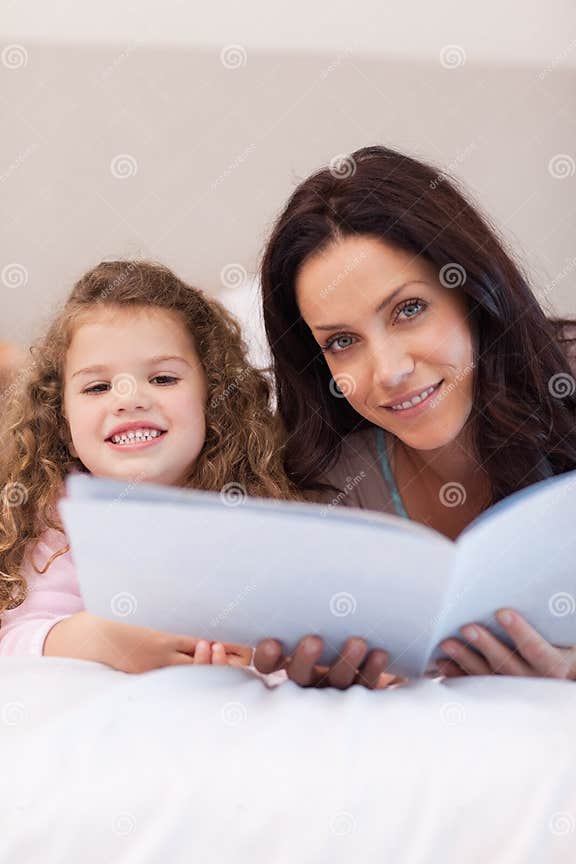 Mother And Daughter Reading Bedtime Stories Together Stock Image