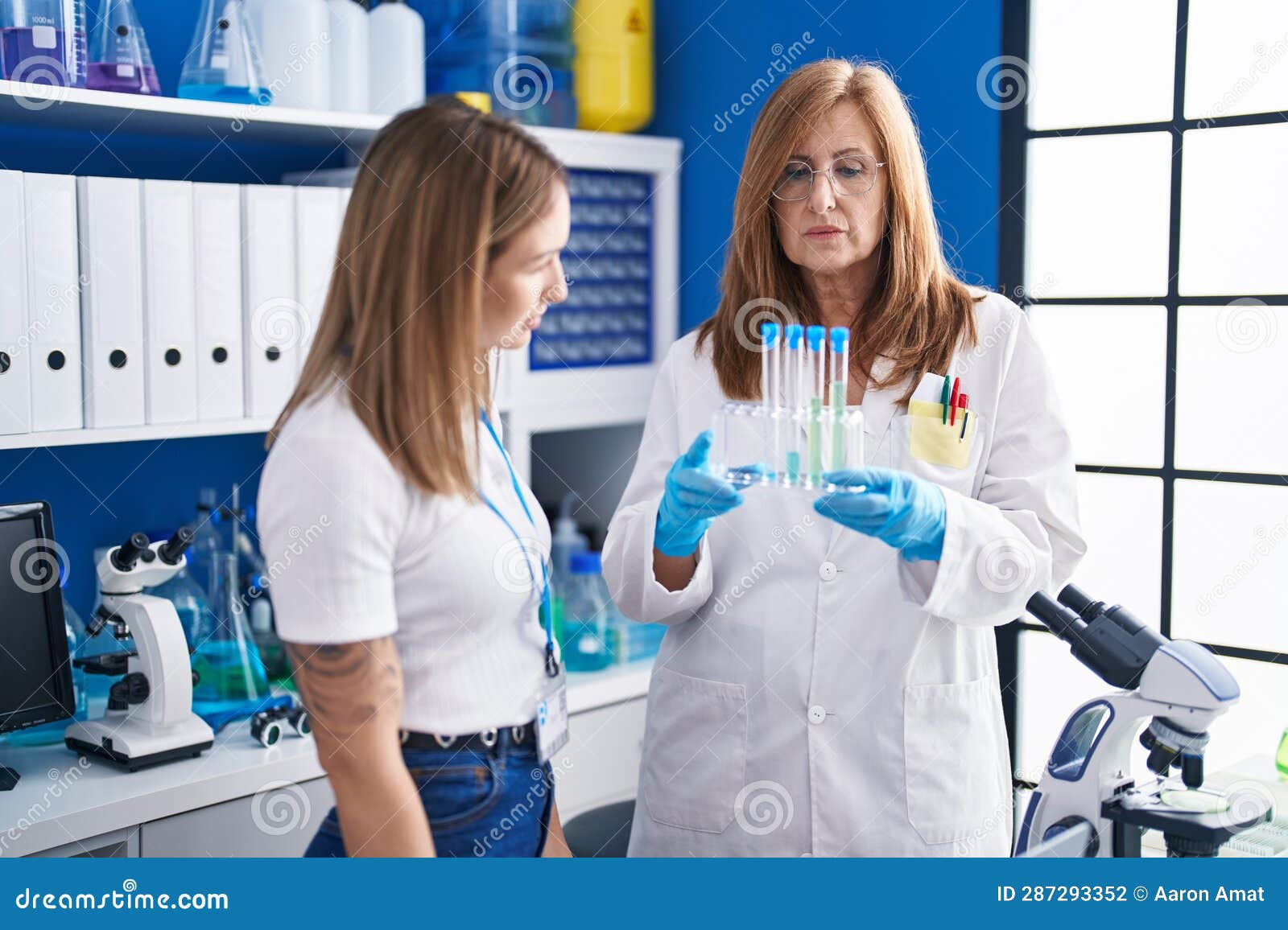 Mother and Daughter Scientists Holding Test Tubes at Laboratory Stock ...
