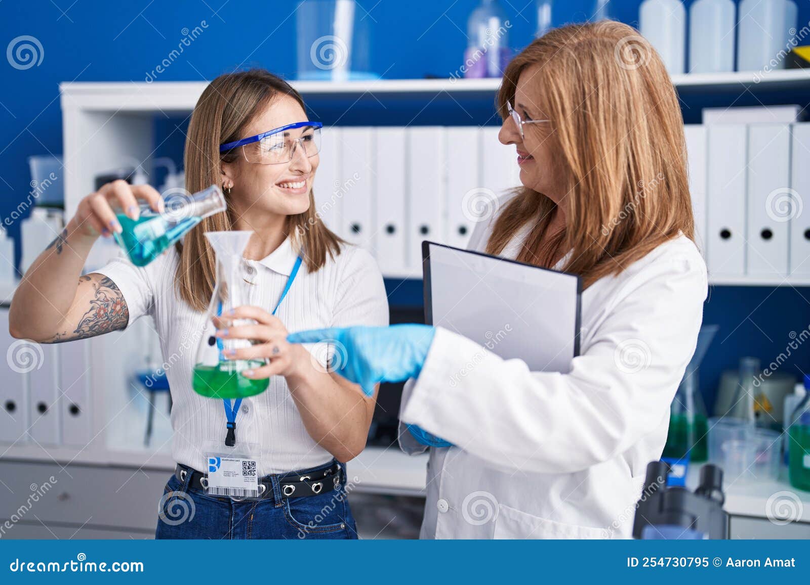 Mother and Daughter Scientists Measuring Liquid at Laboratory Stock ...