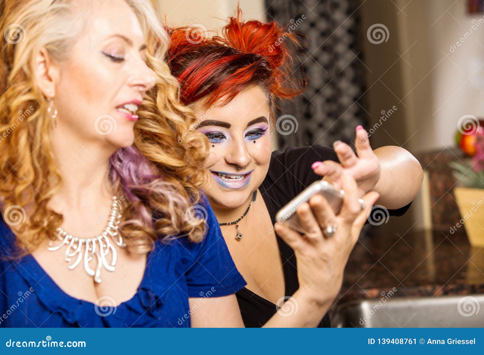 Mother and Red Haired Daughter Share Phone Stock Image - Image of ...