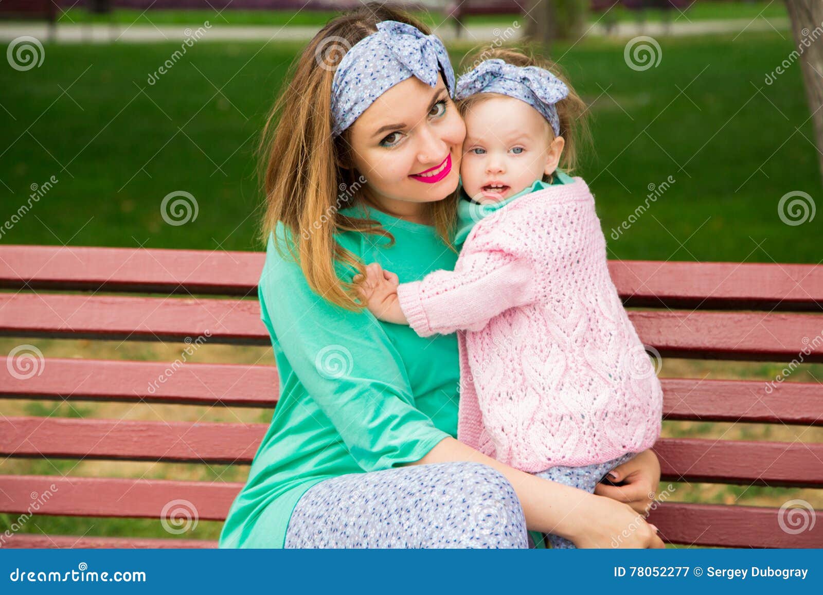 Mother and Daughter Sitting on a Bench Stock Image - Image of grass ...