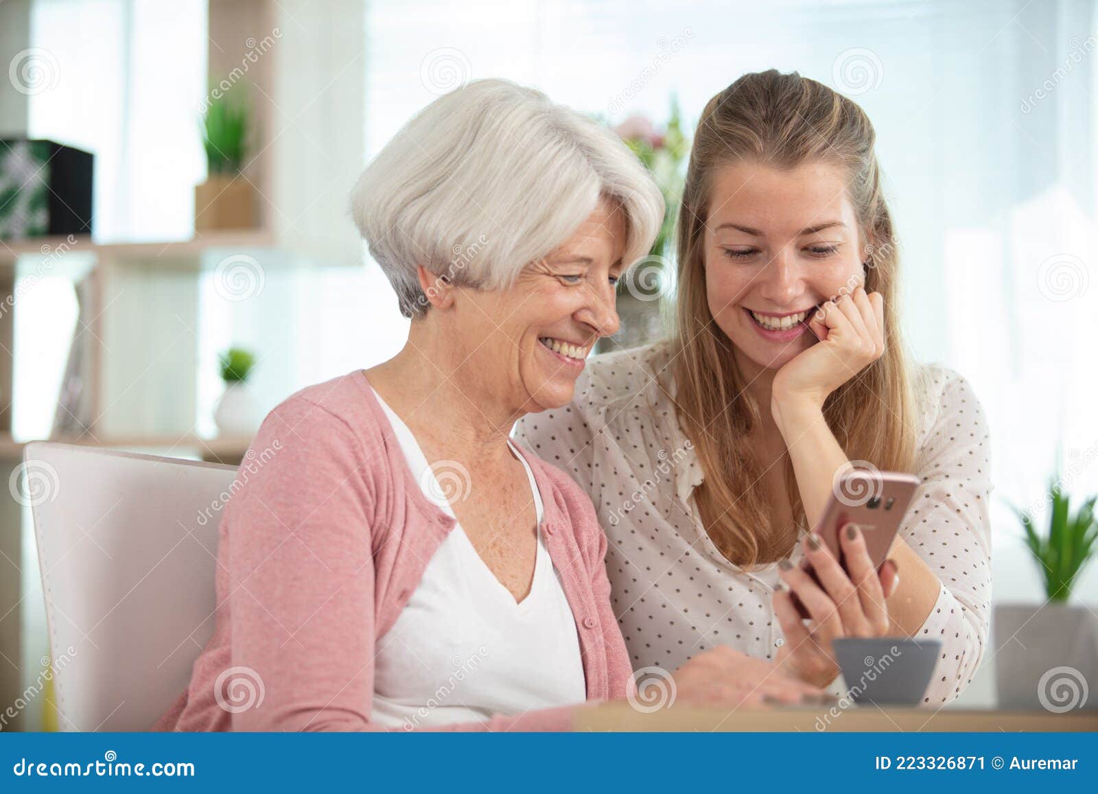 Mother with Daughter Sitting on Sofa Using Social Media Stock Image ...