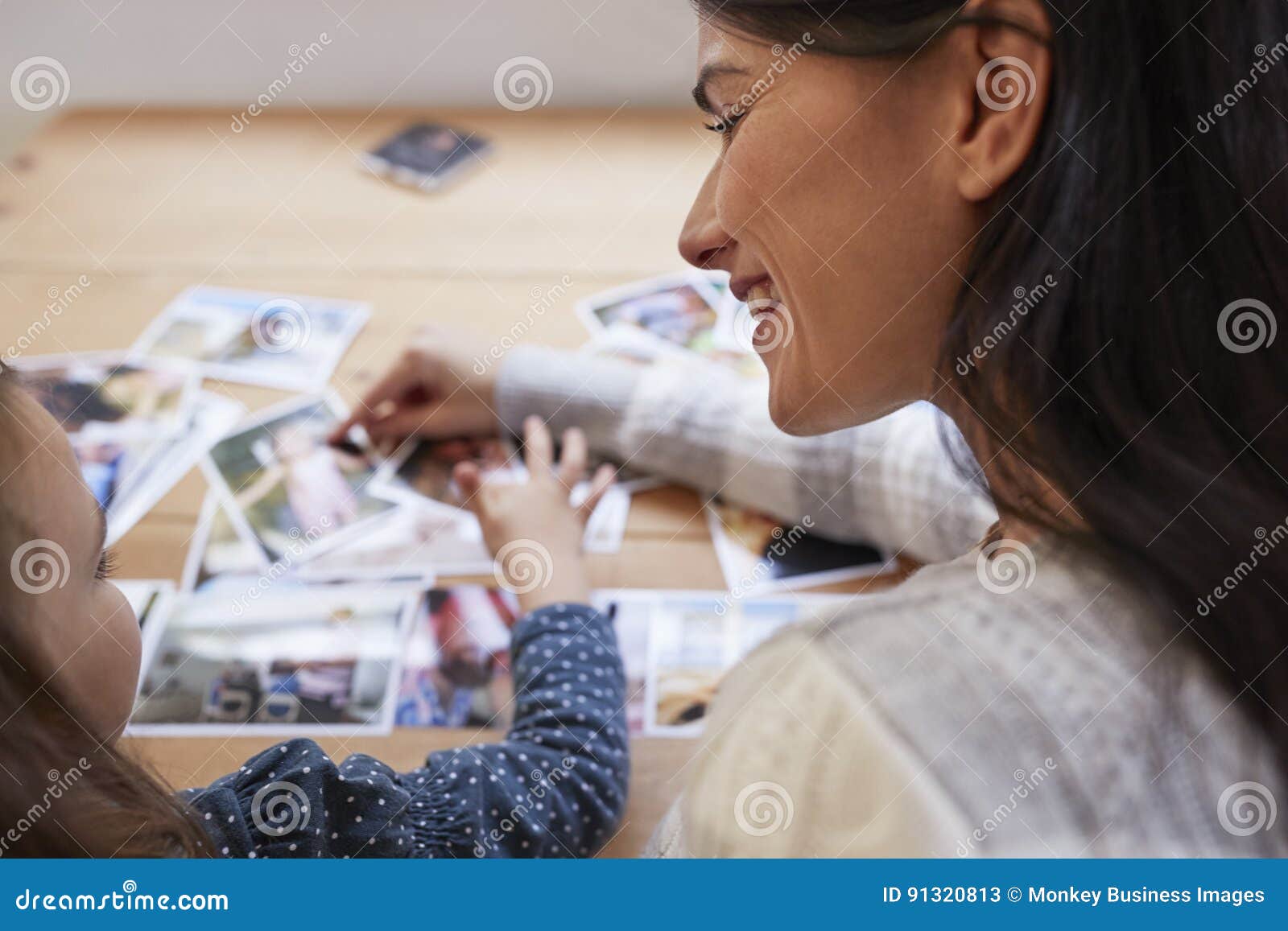 Mother And Daughter Sitting At Table Looking Photos Stock Image Image