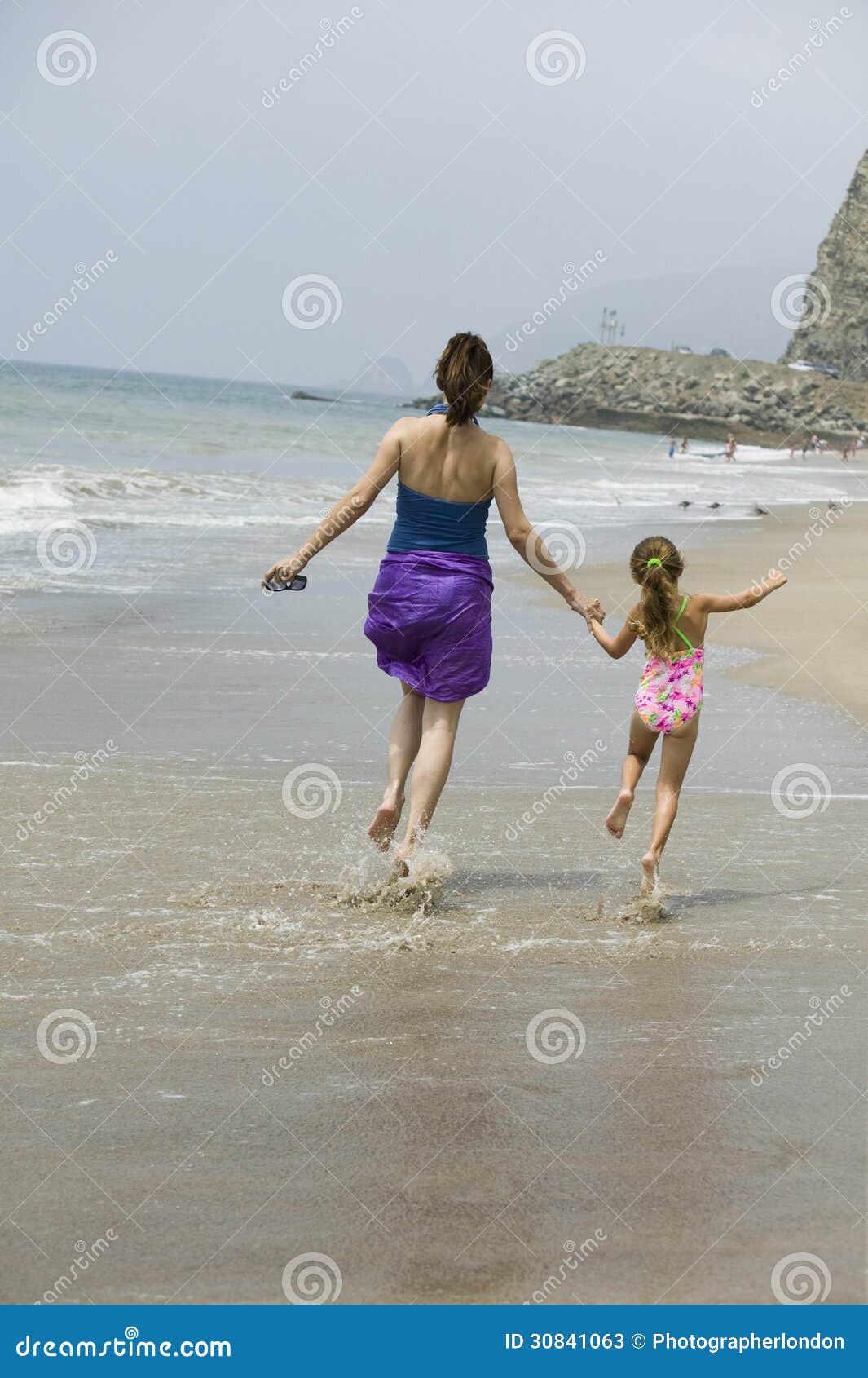 Mother and Daughter Skipping on Beach Stock Image - Image of beach ...