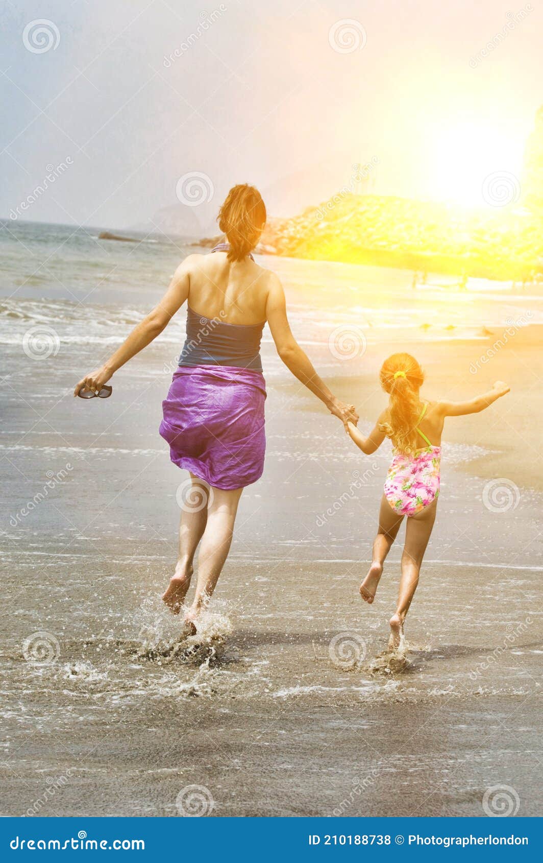 Mother and Daughter Skipping on Beach Stock Photo - Image of concept ...