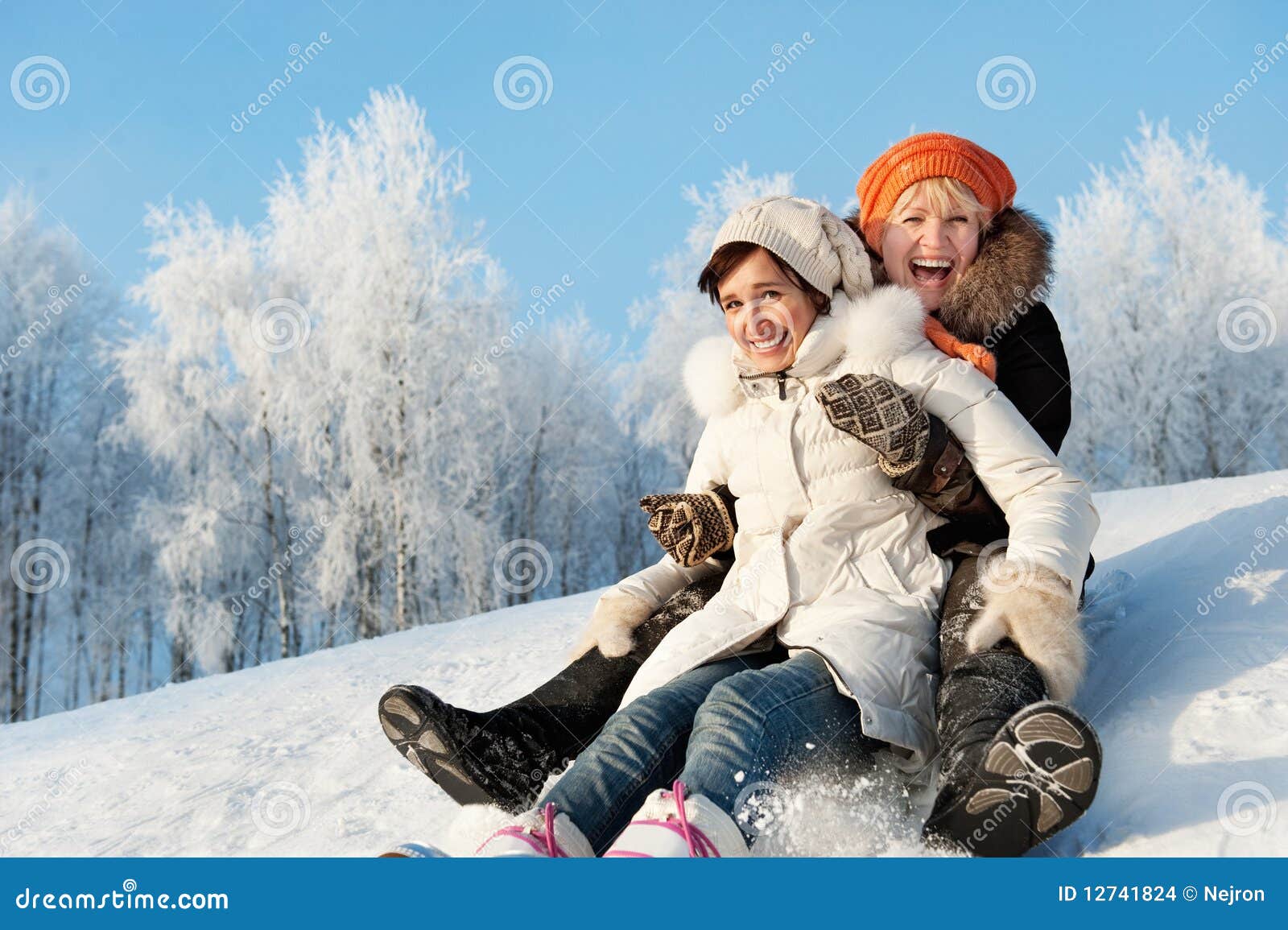 Mother and Daughter Sliding in the Snow Stock Photo - Image of slippery ...