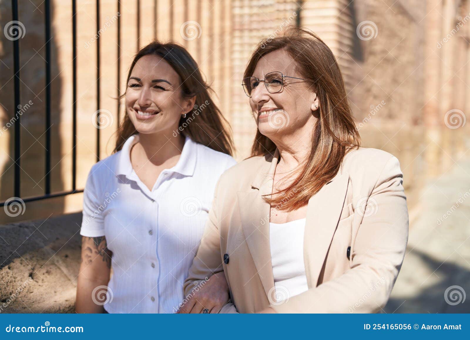 Mother And Daughter Smiling Confident Standing Together At Street Stock