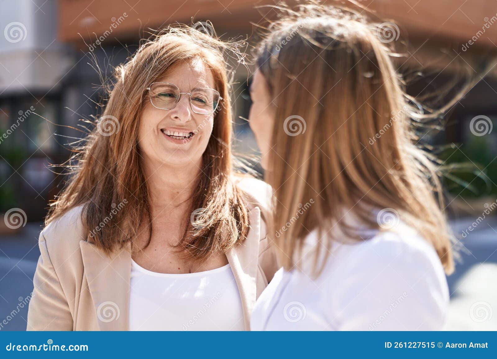 Mother And Daughter Smiling Confident Standing Together At Street Stock
