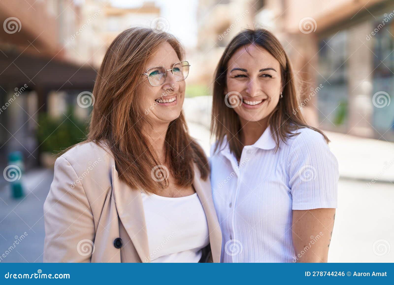 Mother And Daughter Smiling Confident Standing Together At Street Stock