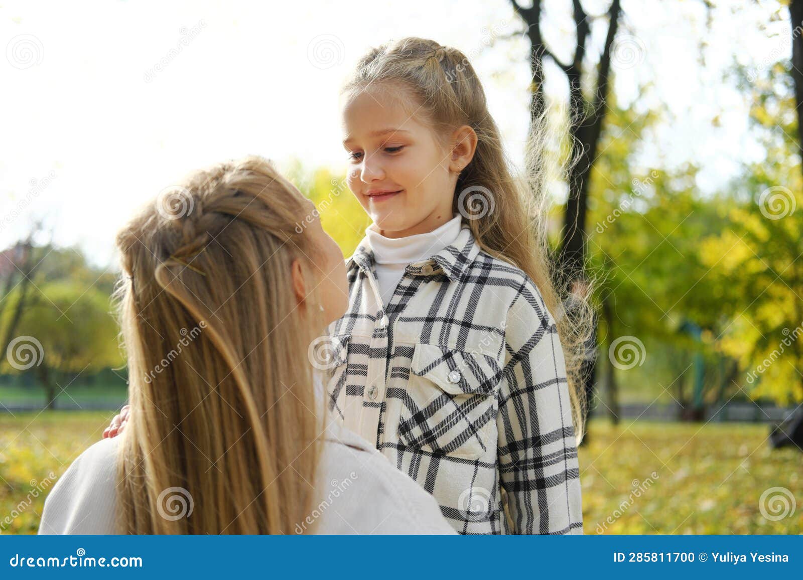 Mother And Daughter Spend Time Together In The Autumn Park Daughter