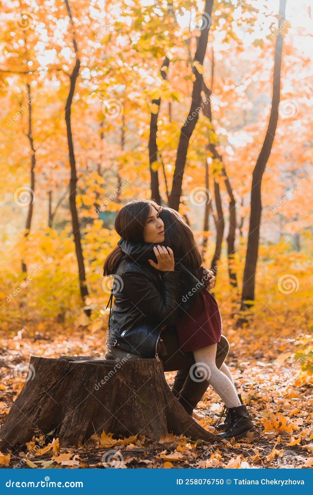 Mother And Daughter Spend Time Together In Autumn Yellow Park Season