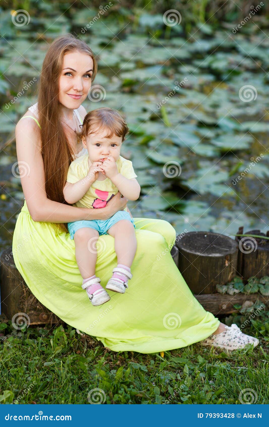 Mother and Daughter in Summer Park Sitting on Stump Stock Photo - Image ...