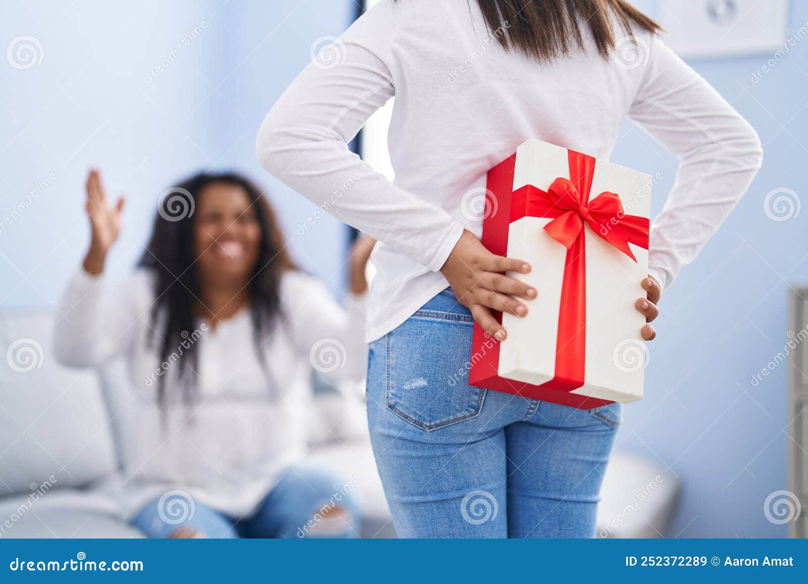 Mother and Daughter Surprise with Gift on Back at Home Stock Image ...