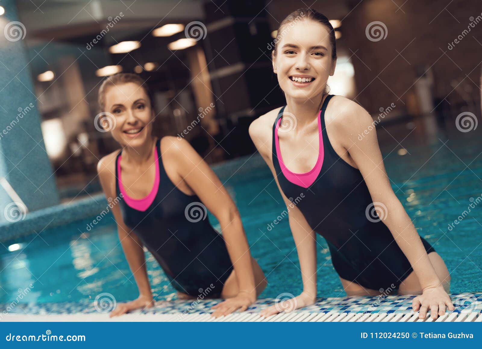 Mother And Daughter At Border Of Pool At The Gym They Look Happy