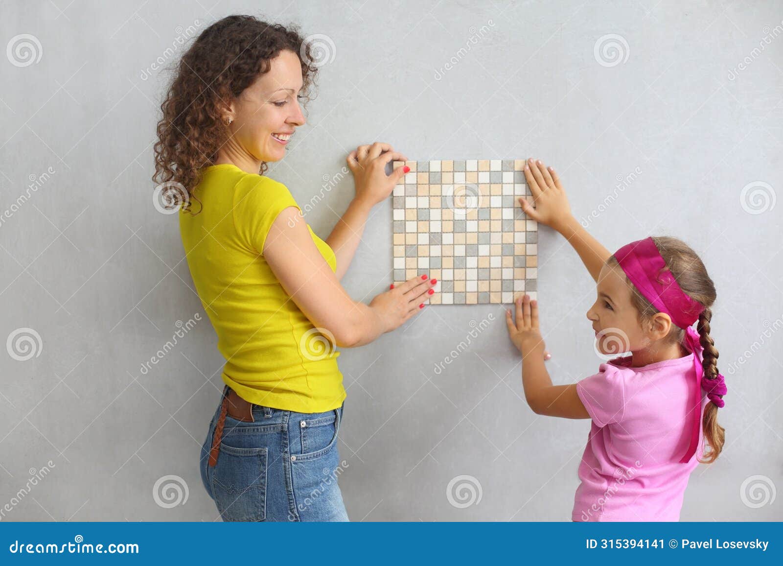 Mother and Daughter Try on the Finishing Tile on Stock Image - Image of ...