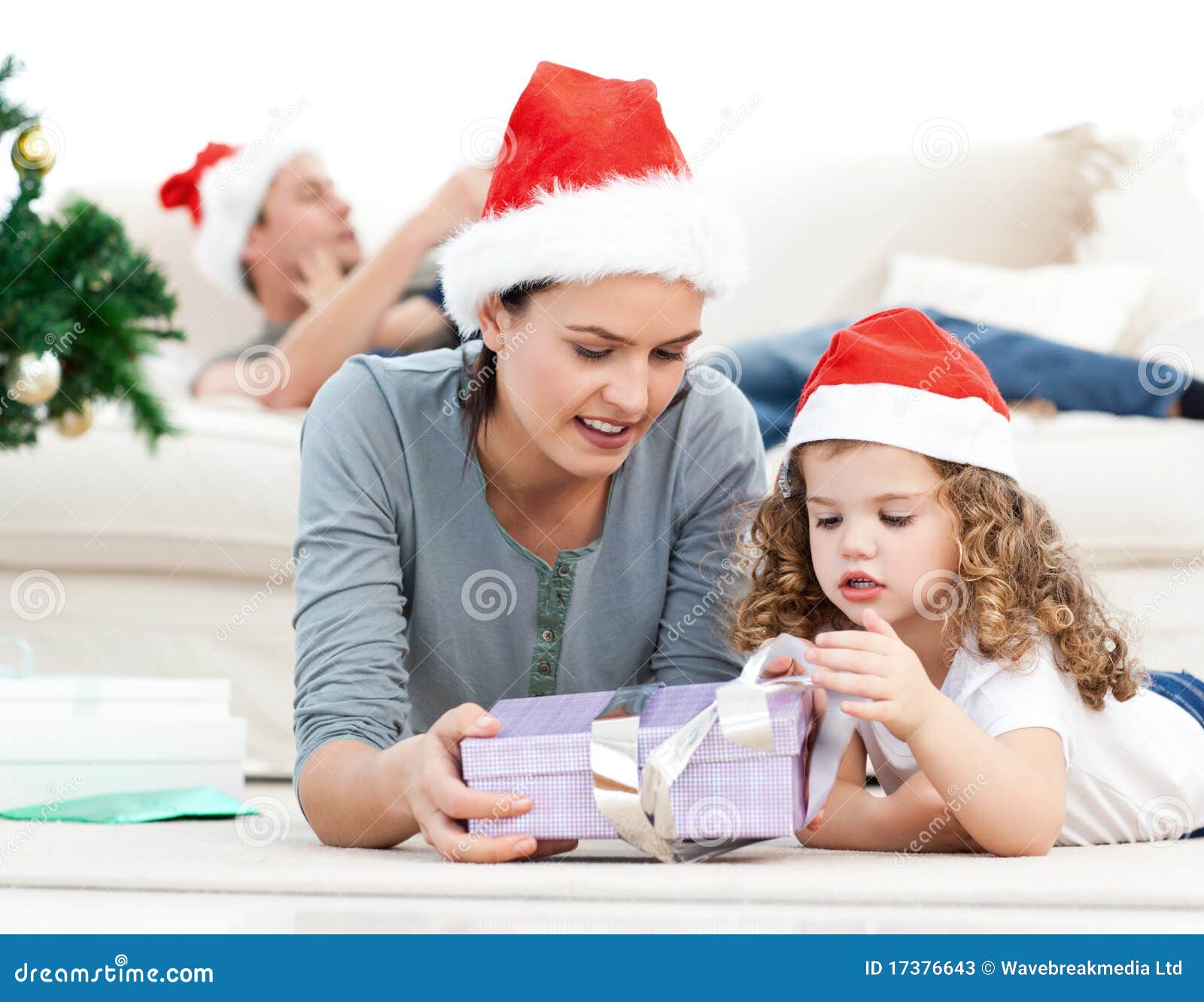 Mother and Daughter Unwrapping a Present Stock Image - Image of lying ...