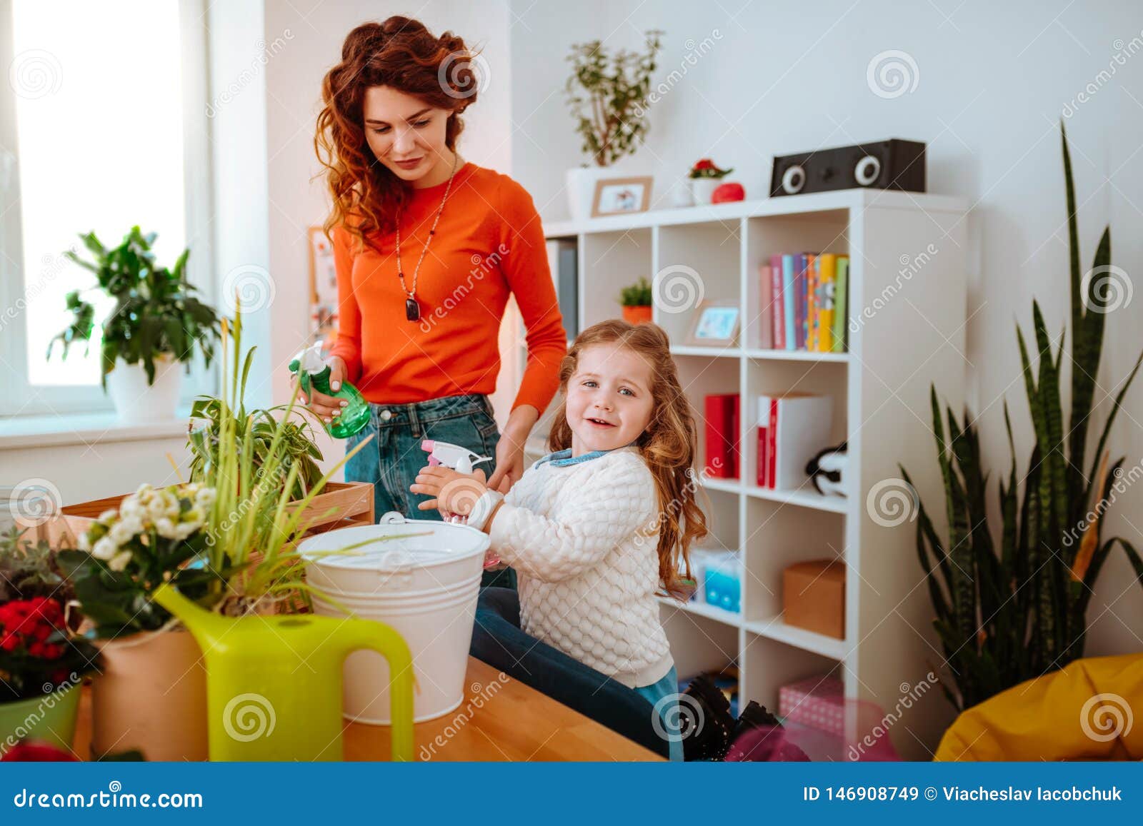 Mother and Daughter Using Diffusers Watering Home Plants Stock Image ...